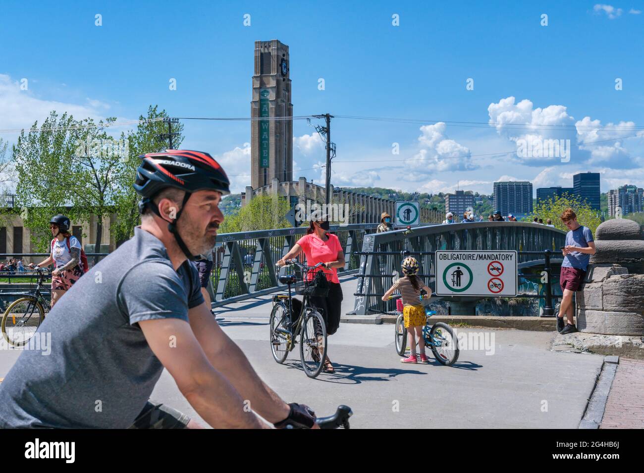 Montreal, CA - 15 May 2021: People riding and biking on Lachine Canal’s ...