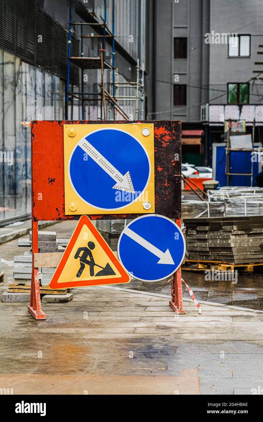 Warning signs about road works. Reconstruction of sidewalk. Road signs ...