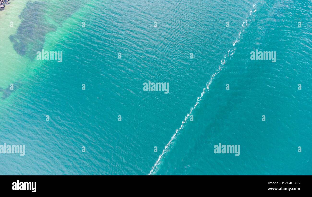 Aerial view of the sea bay. Blue water and boat trail Stock Photo - Alamy