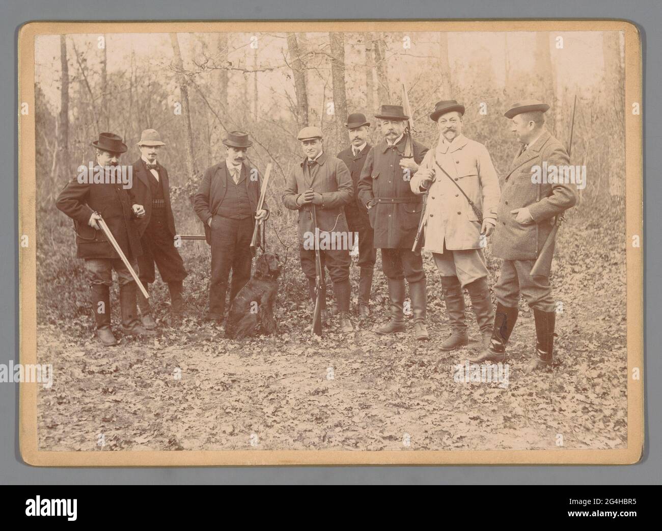 Group portrait of hunters with a dog in a forest Stock Photo - Alamy