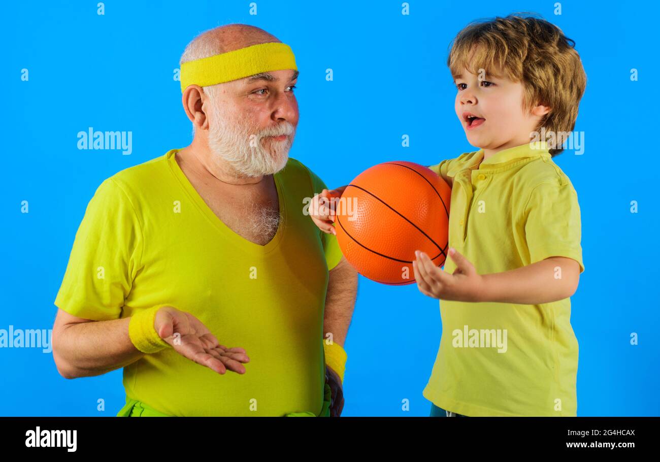 Sportsman grandfather and healthy kid with basketball ball. Sport for ...