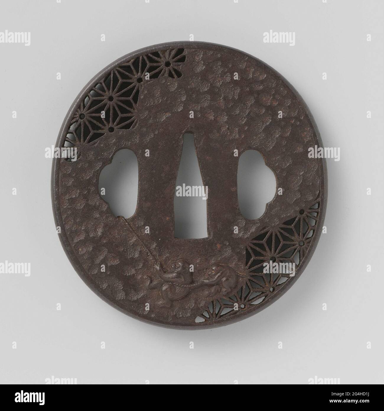 . Oval tsuba with two fields with openwork decoration in positive ...