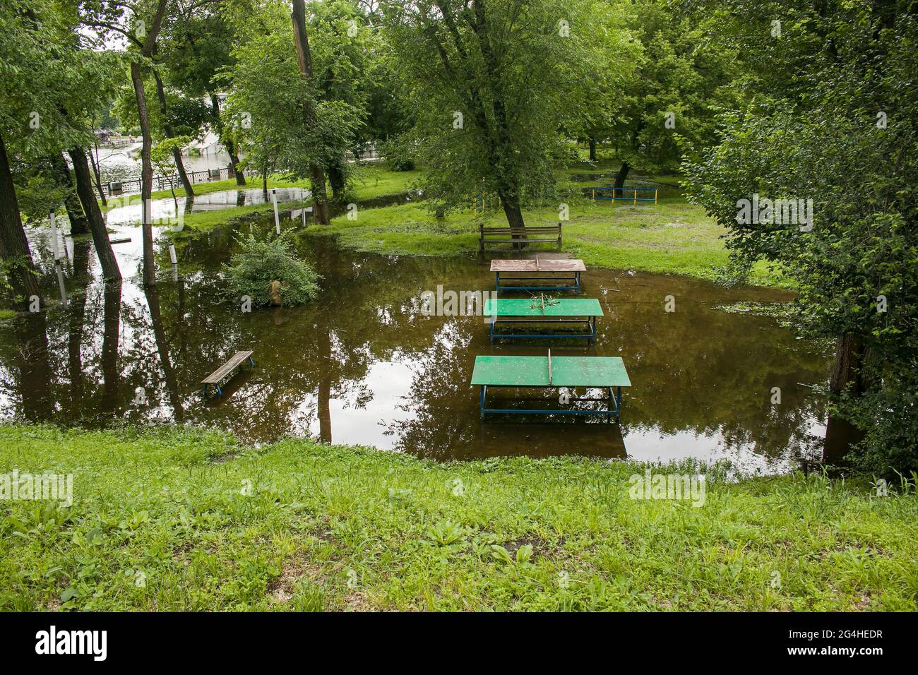 Public park drenched in rain. Water logged park.Wet benches. Park ...