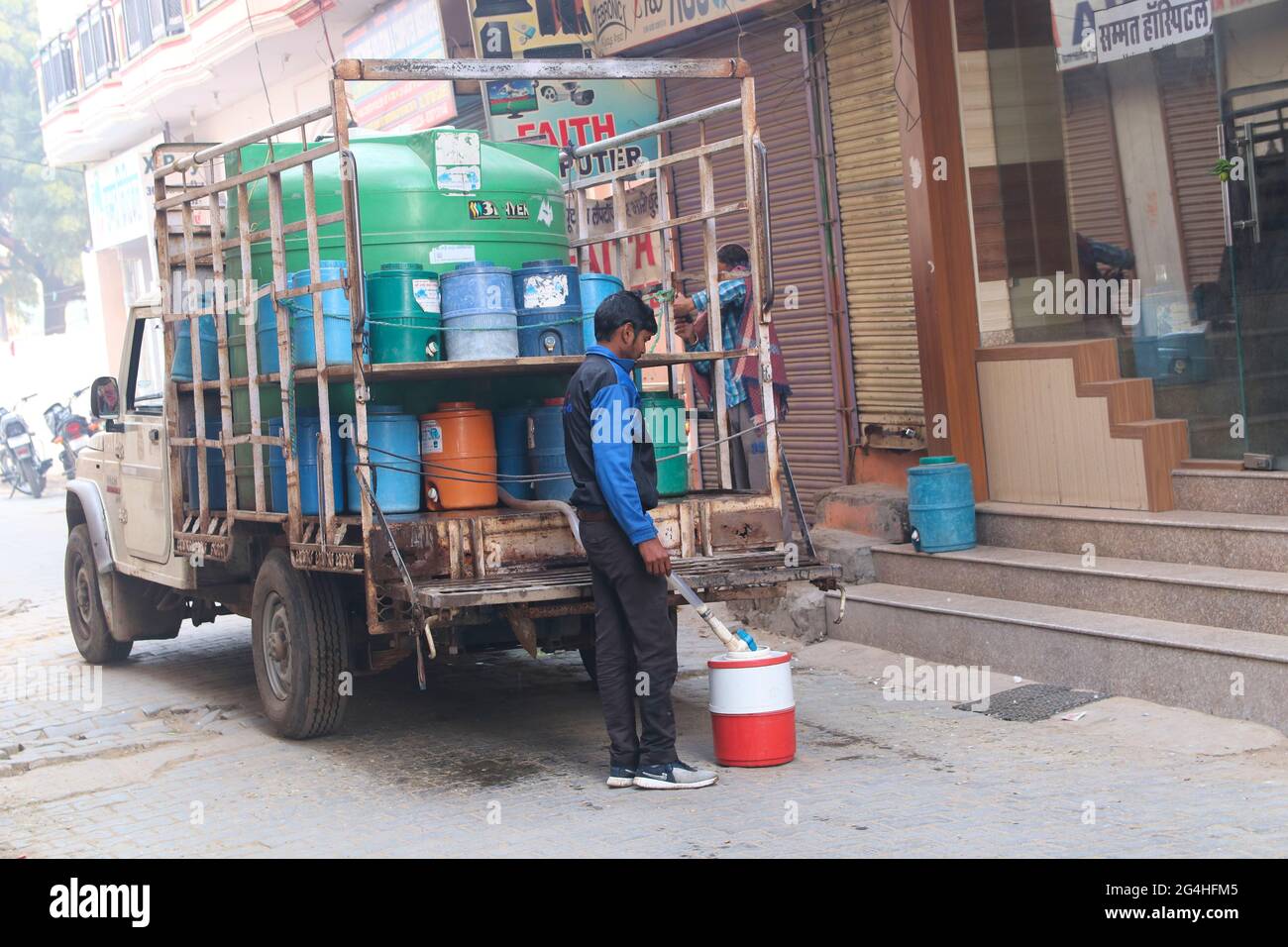 The seller of drinking water brought barrels of water to customers ...