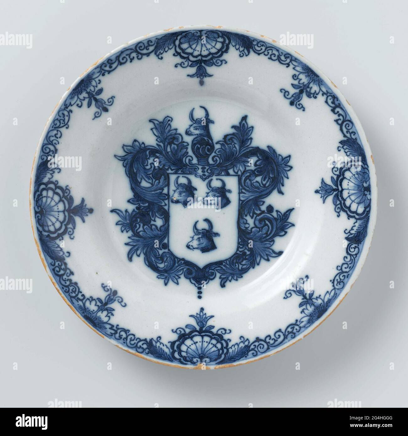 . Plate of faience, painted in blue with a weapon with three cows or ox ...