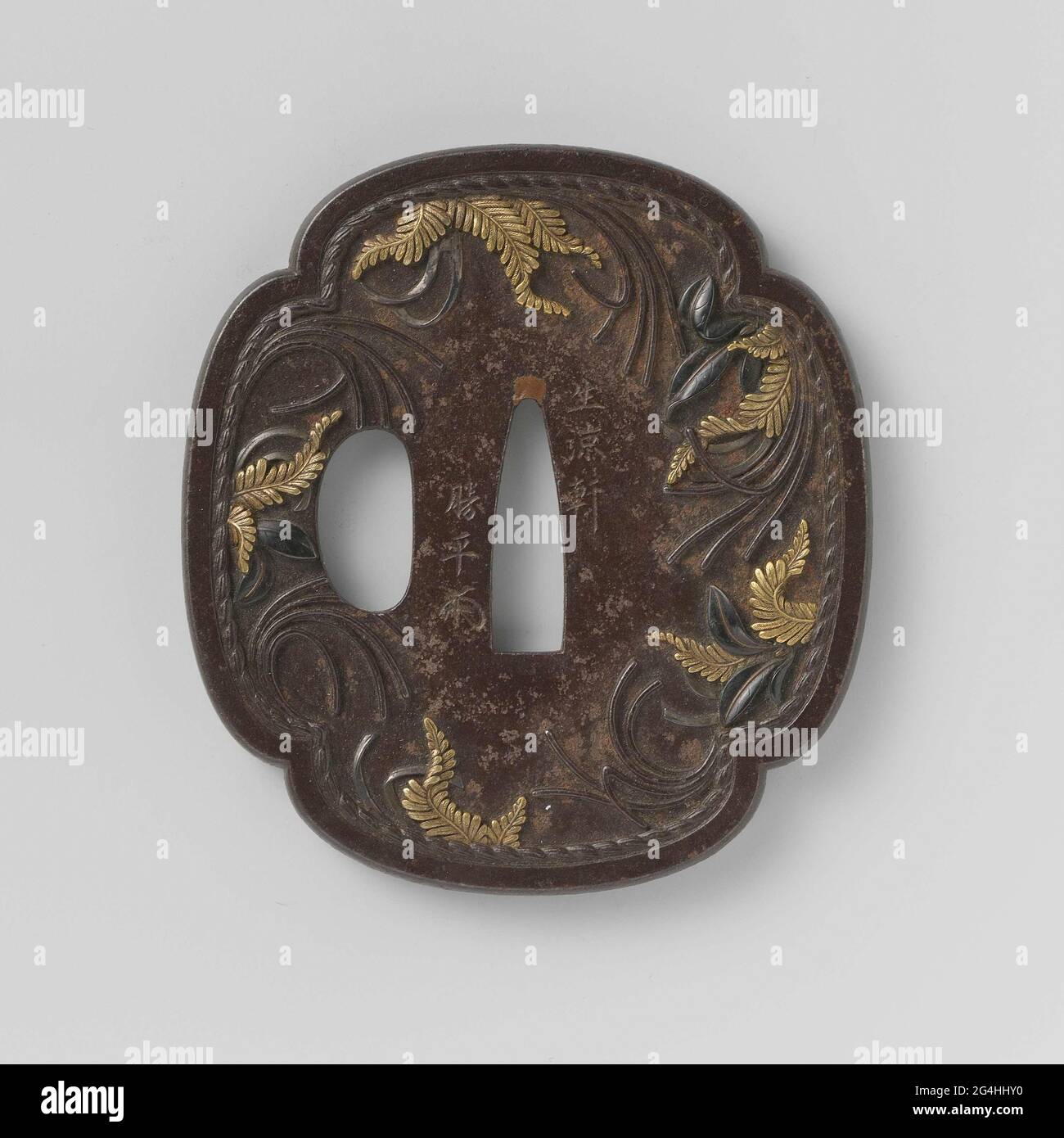 . Mokko-shaped tsuba with raised edge; On both sides, a sliced ...