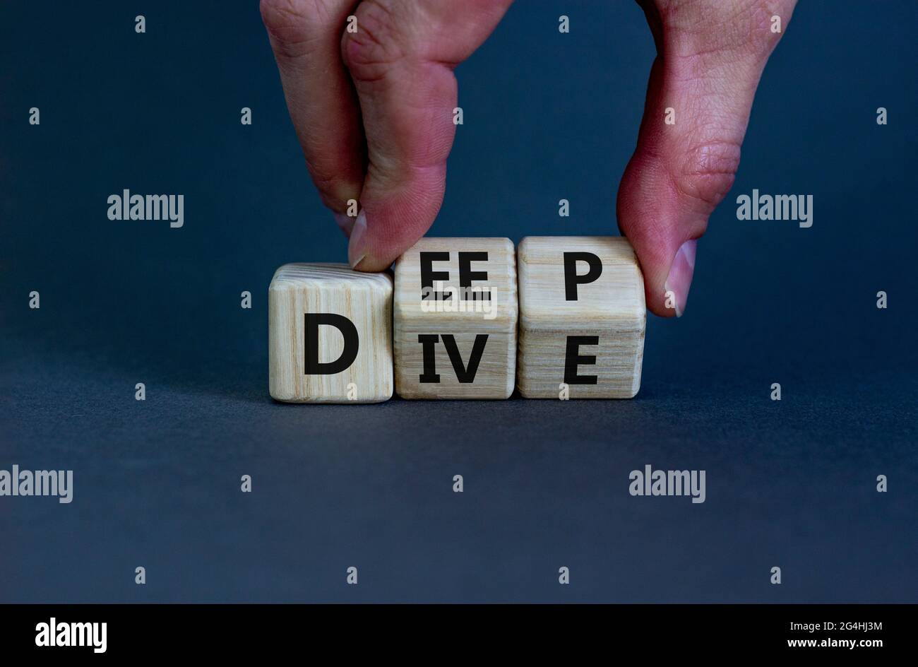 Deep dive symbol. Businessman turns wooden cubes with words 'Deep dive ...