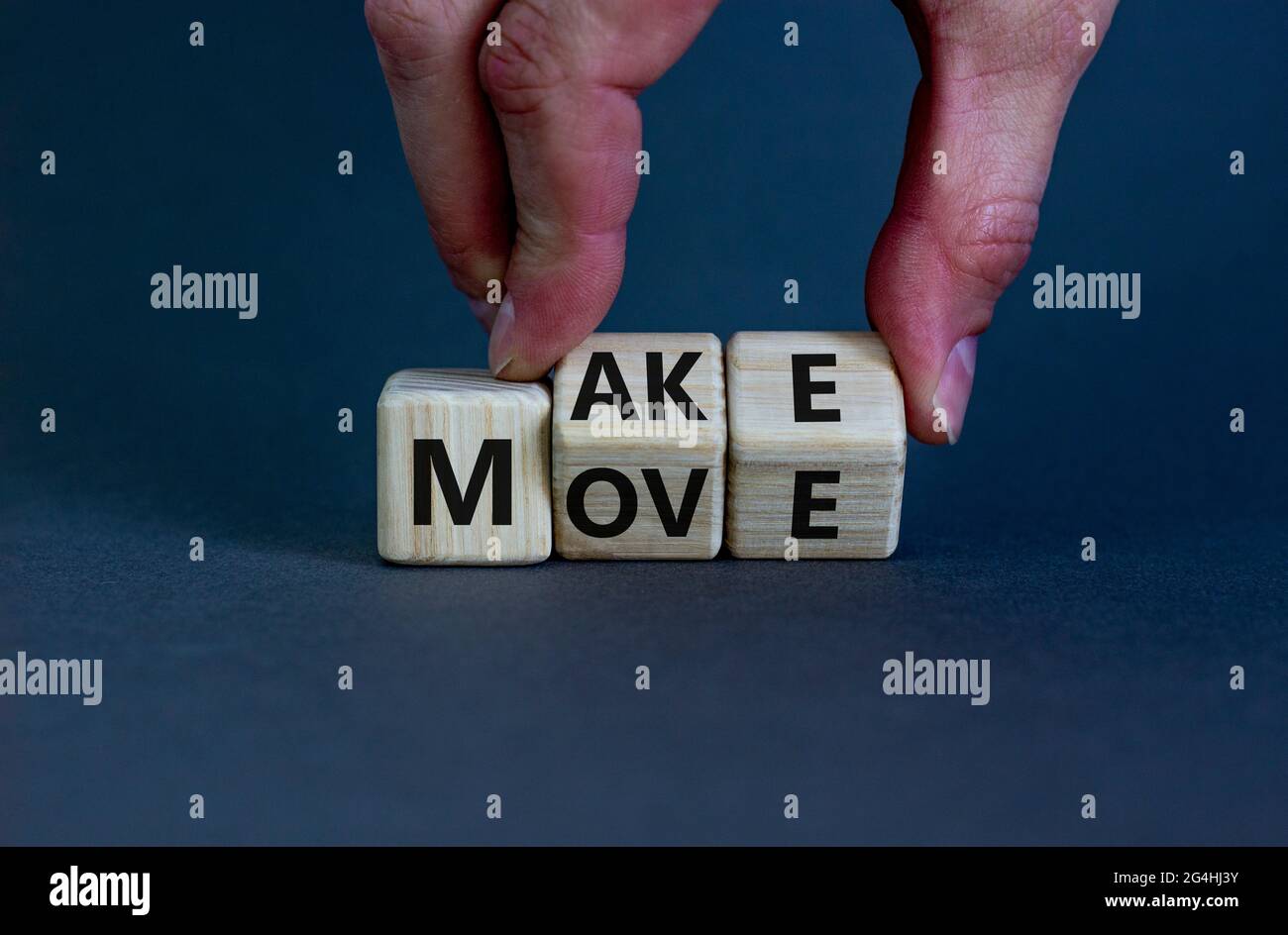 Make your move symbol. Businessman turns wooden cubes with words 'Make ...