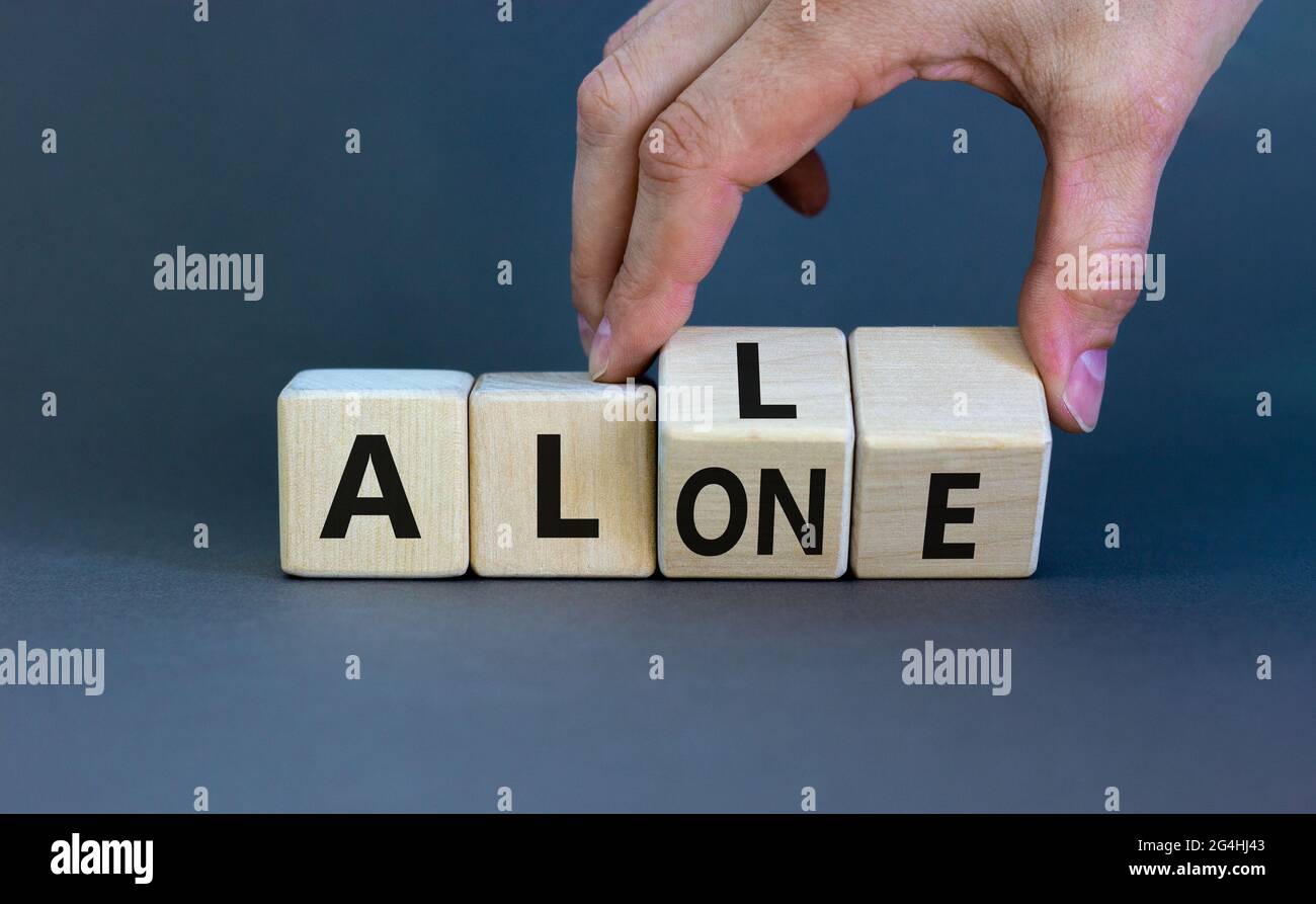 All or alone and support symbol. Businessman turns the wooden cube and ...