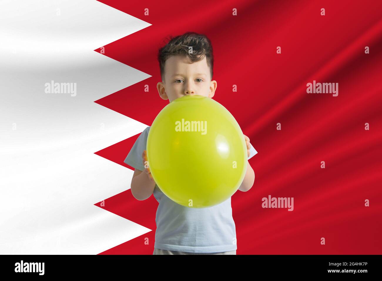 Children's day in Bahrain. White boy with a balloon on the background ...