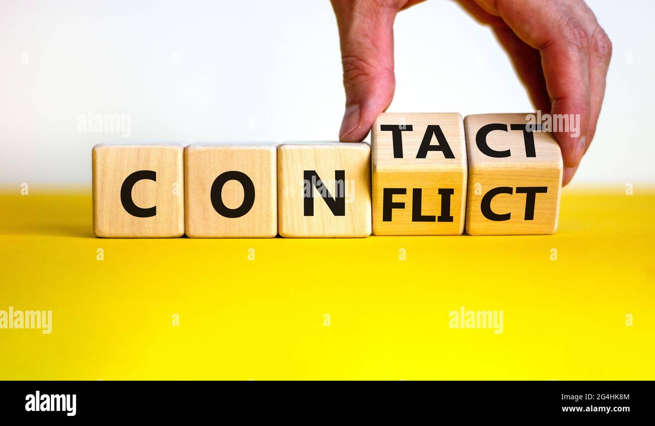 Conflict or contact symbol. Businessman turns wooden cubes and changes ...