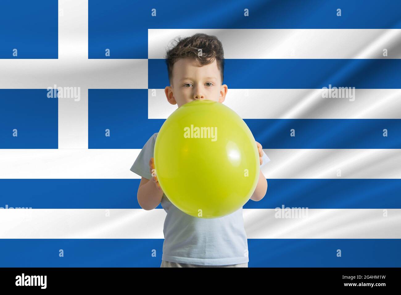 Children's day in Greece. White boy with a balloon on the background of ...