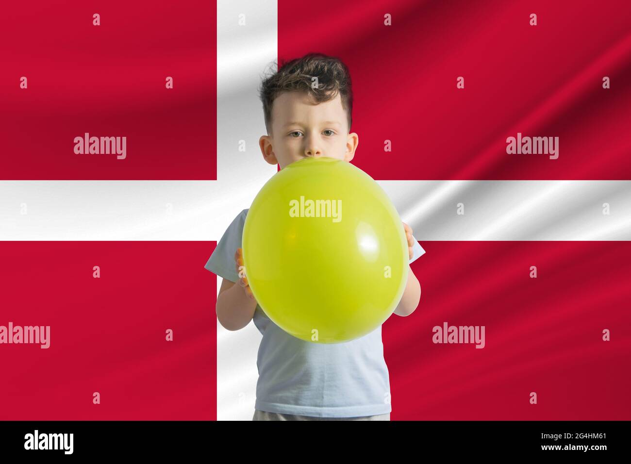 Children's day in Denmark. White boy with a balloon on the background ...