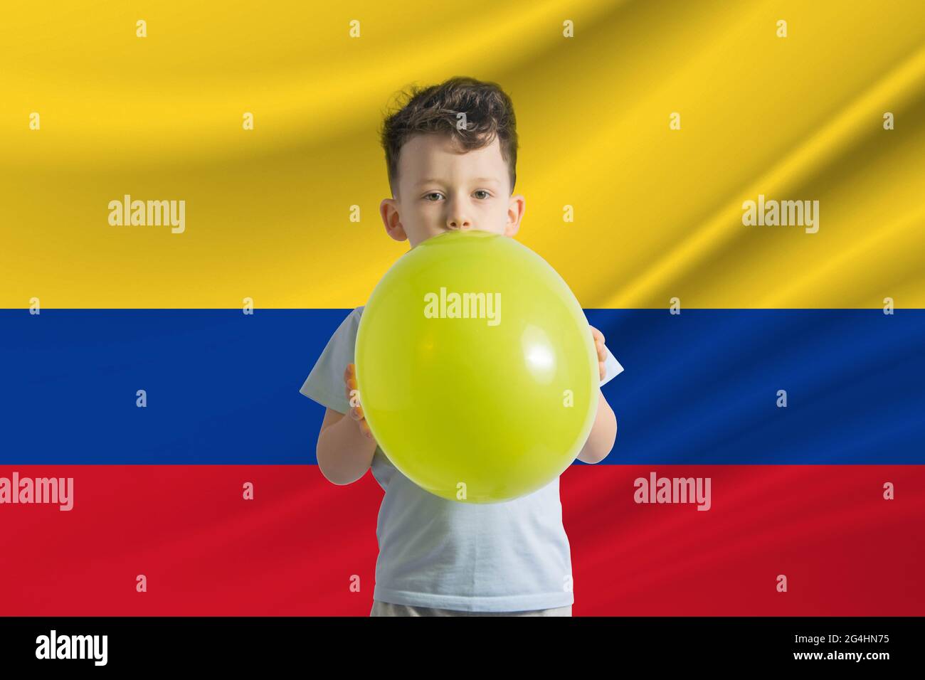 Children's day in Colombia White boy with a balloon on the background ...