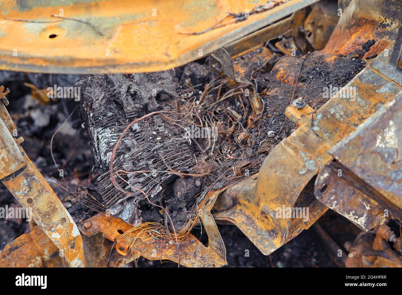 Burnt-out rusty cars on a city street, vandalism. Setting fire to cars ...