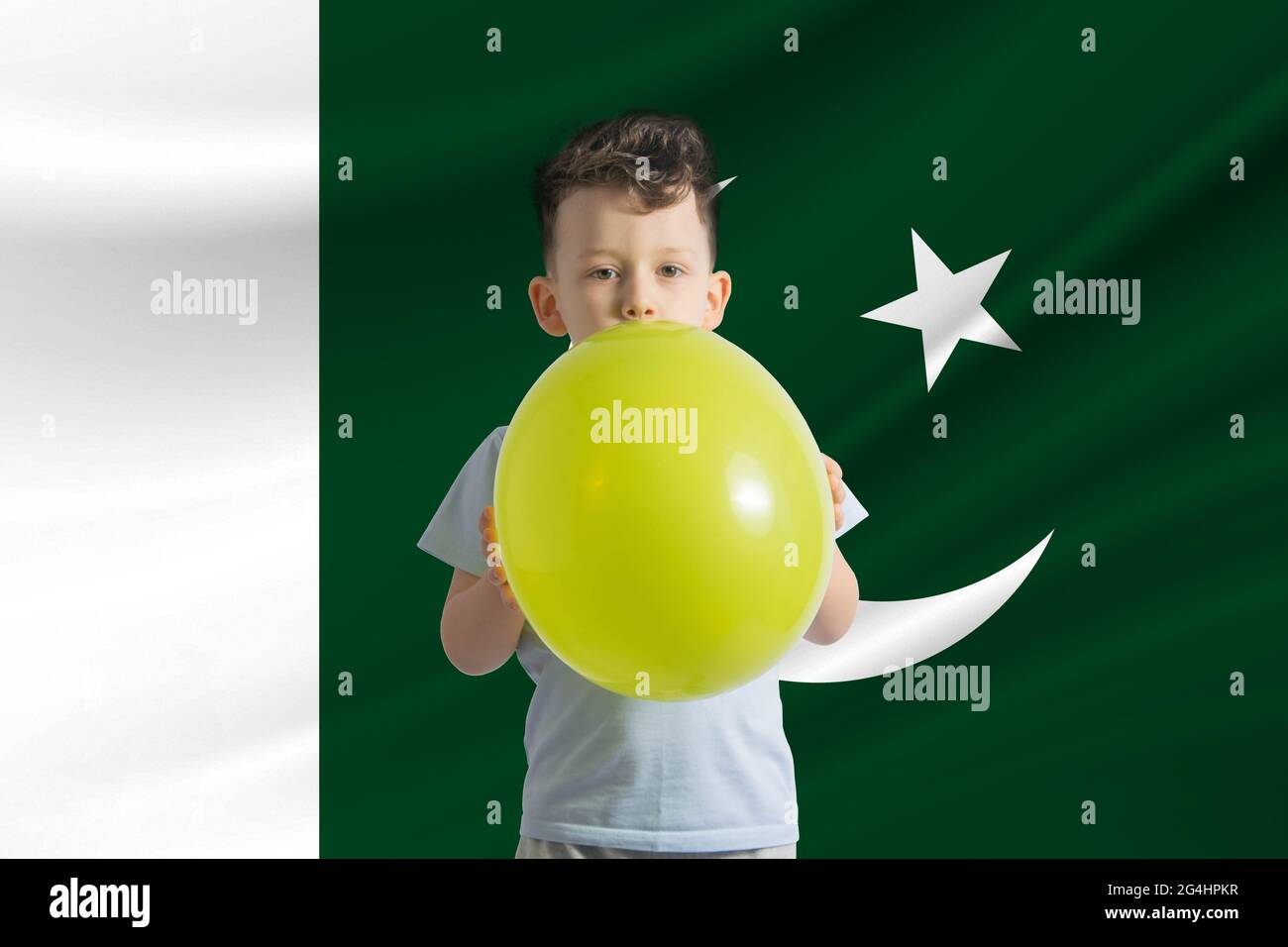 Children's day in Pakistan. White boy with a balloon on the background ...