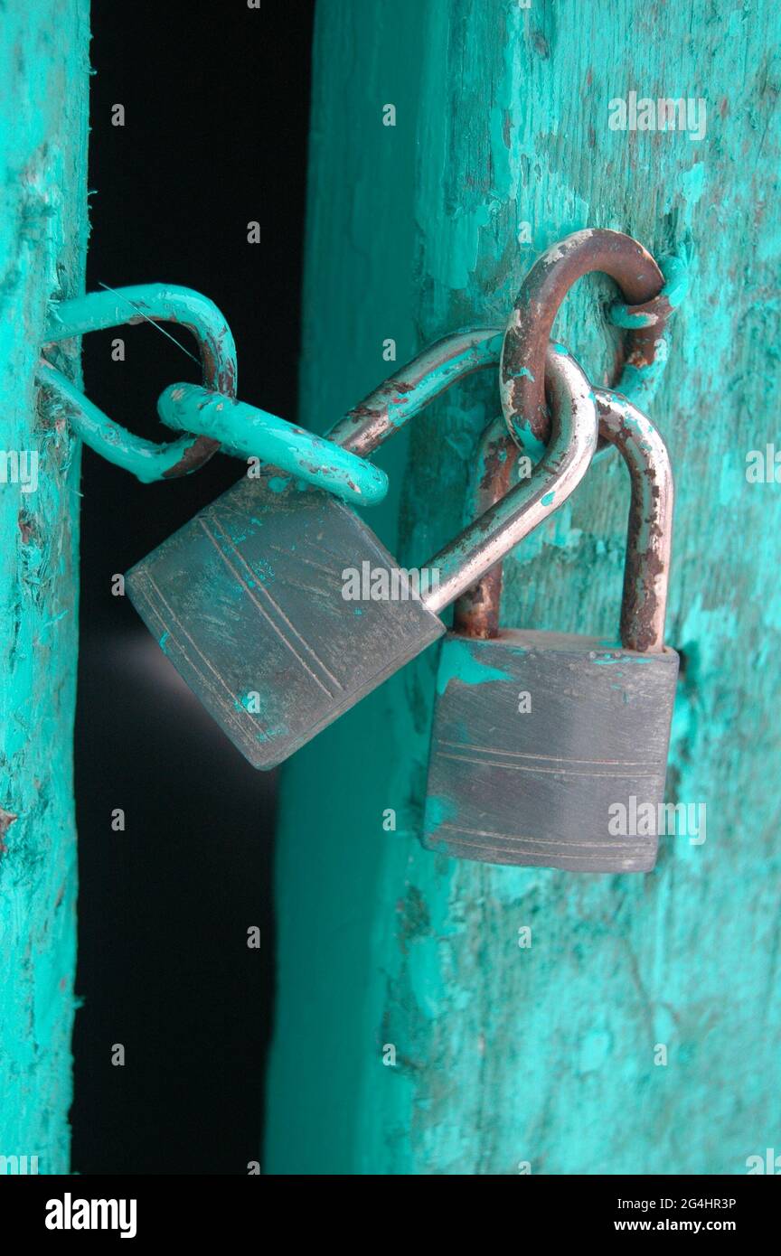 two old padlocks on green door in mexican town Stock Photo - Alamy