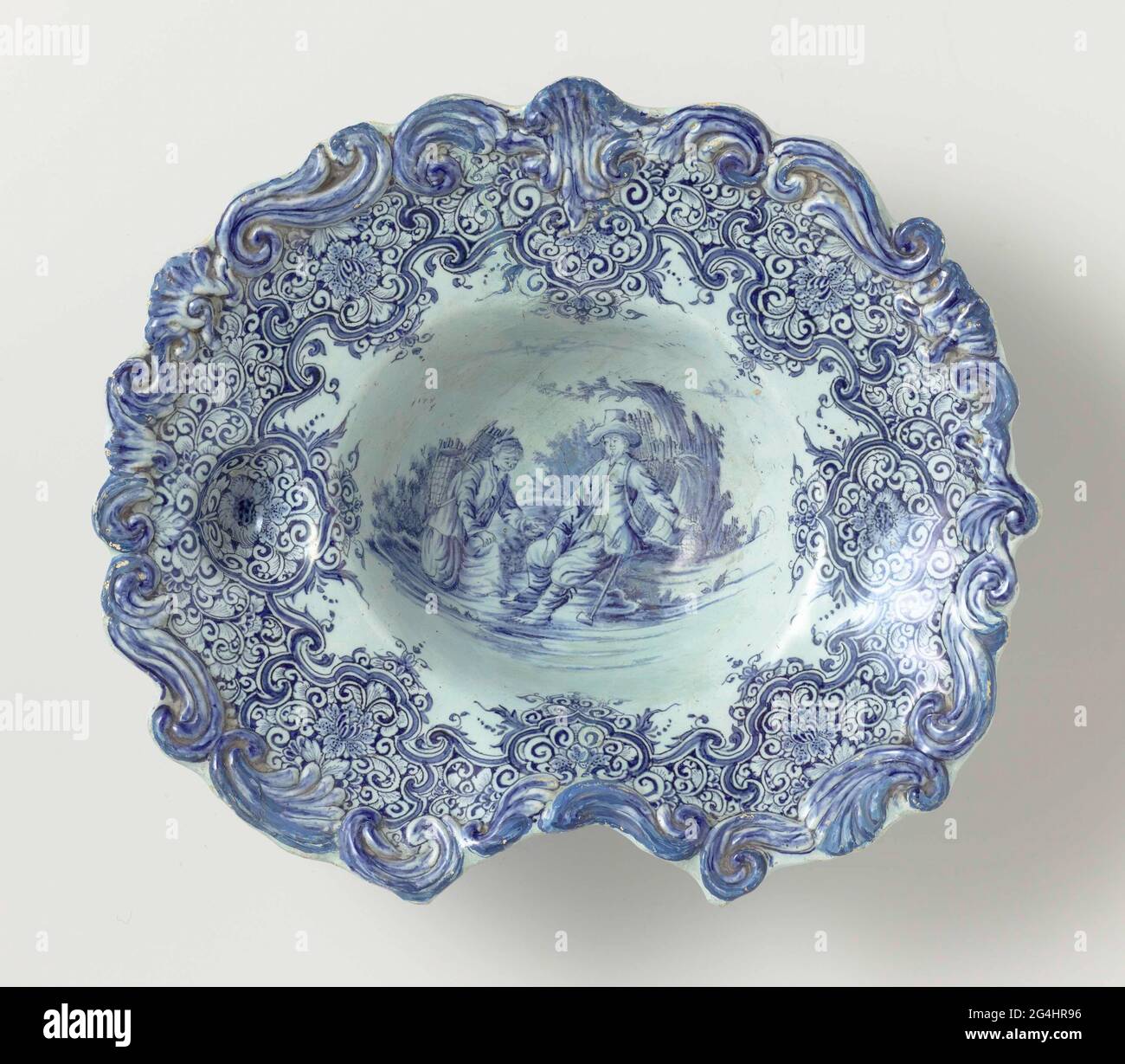 . Shaving basin of blue painted faïence with representation of two ...
