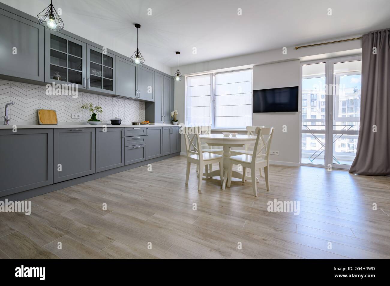 Trendy grey and white modern kitchen furniture in studio apartment ...