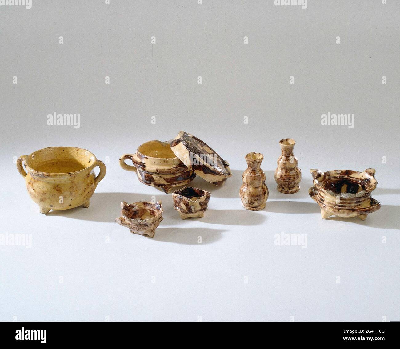 . Bottle of pottery with pale yellow shard and brown plumbing. The ...