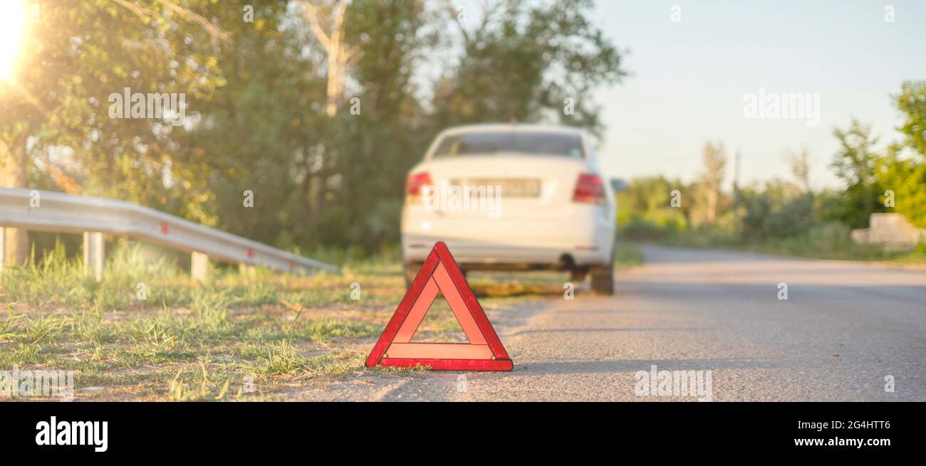 red triangle sign on the road as the symbol of the car crash accident ...