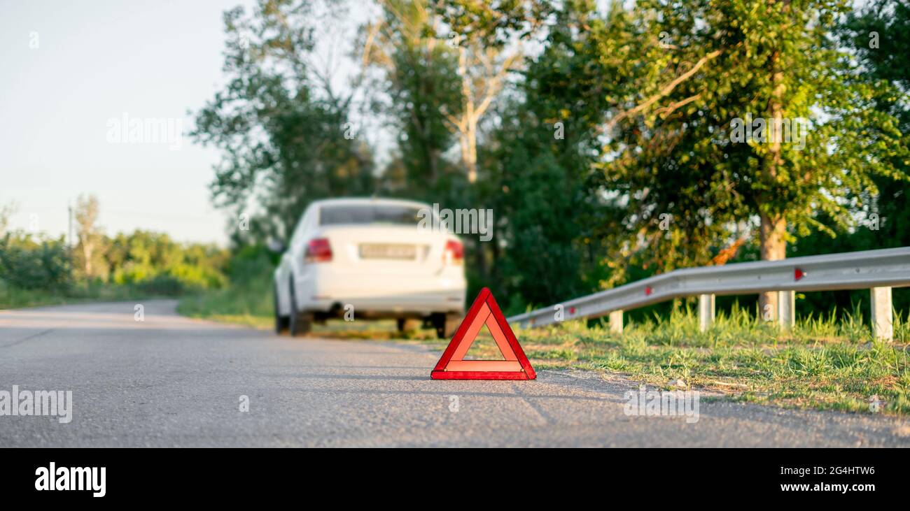red triangle sign on the road as the symbol of the car crash accident ...