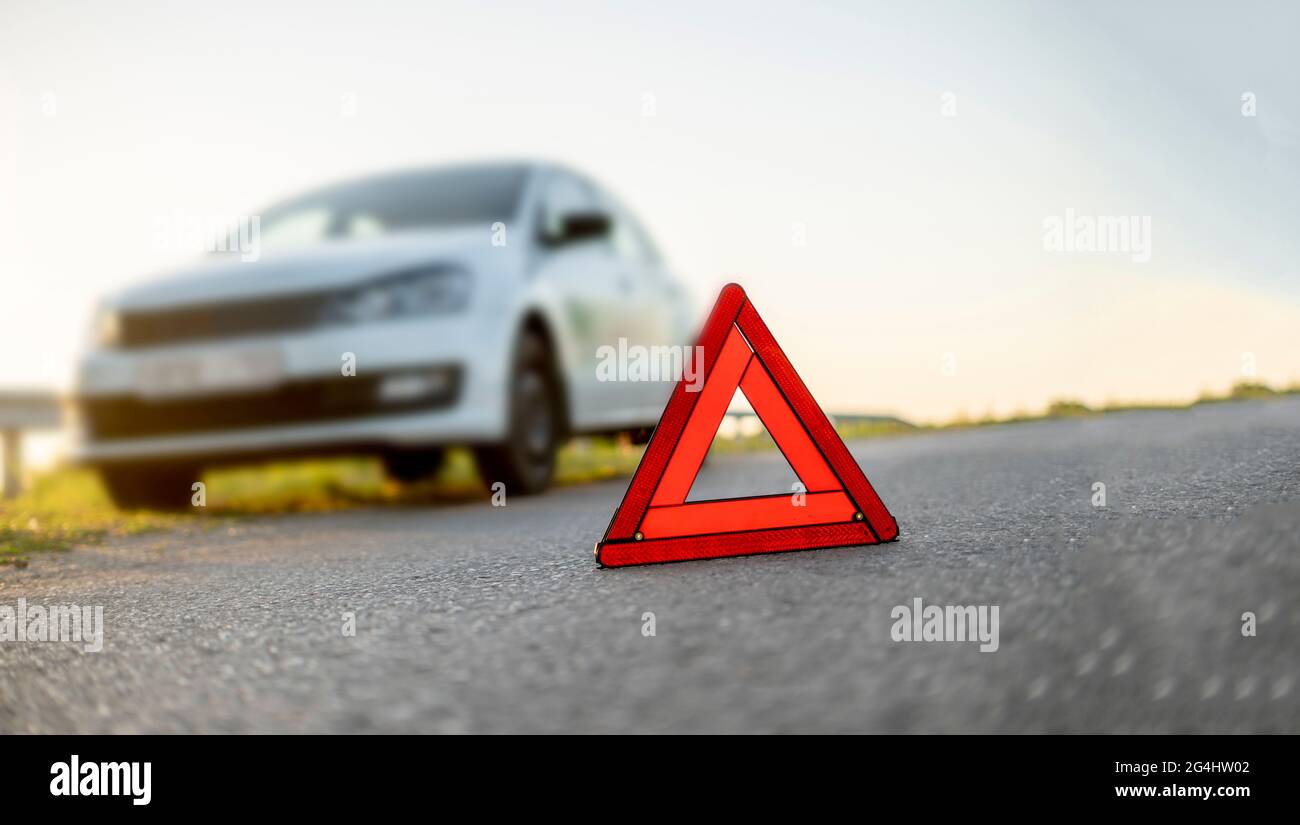 red triangle sign on the road as the symbol of the car crash accident ...