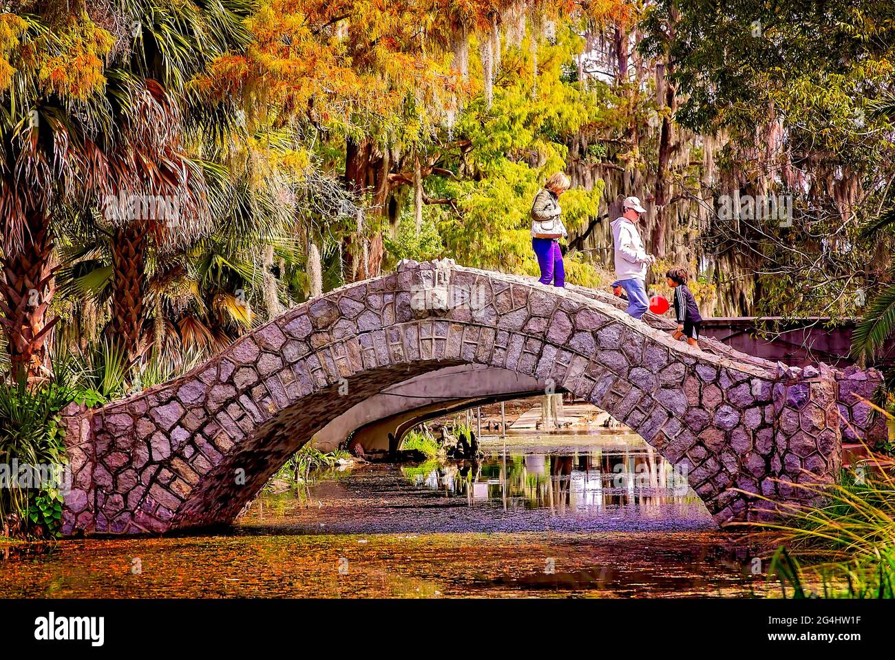 Tourists walk across Langles Bridge in New Orleans City Park, Nov. 14 ...