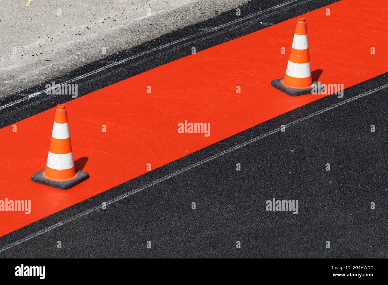 red and white pylons on a freshly red-marked cycle track Stock Photo ...