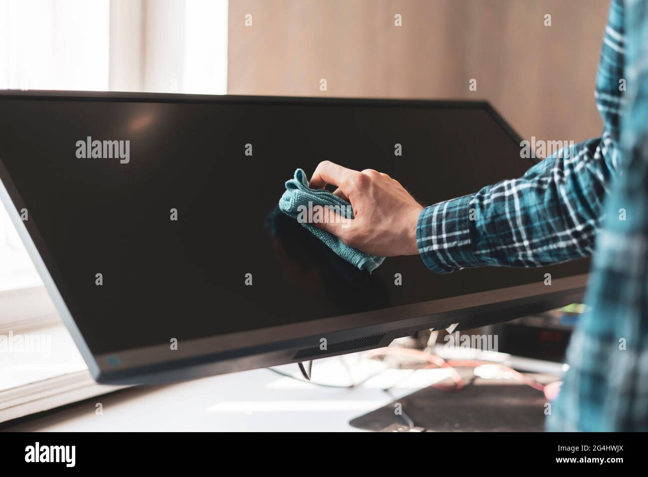 hand holding a rag and wipe a digital monitor screen of device Stock ...