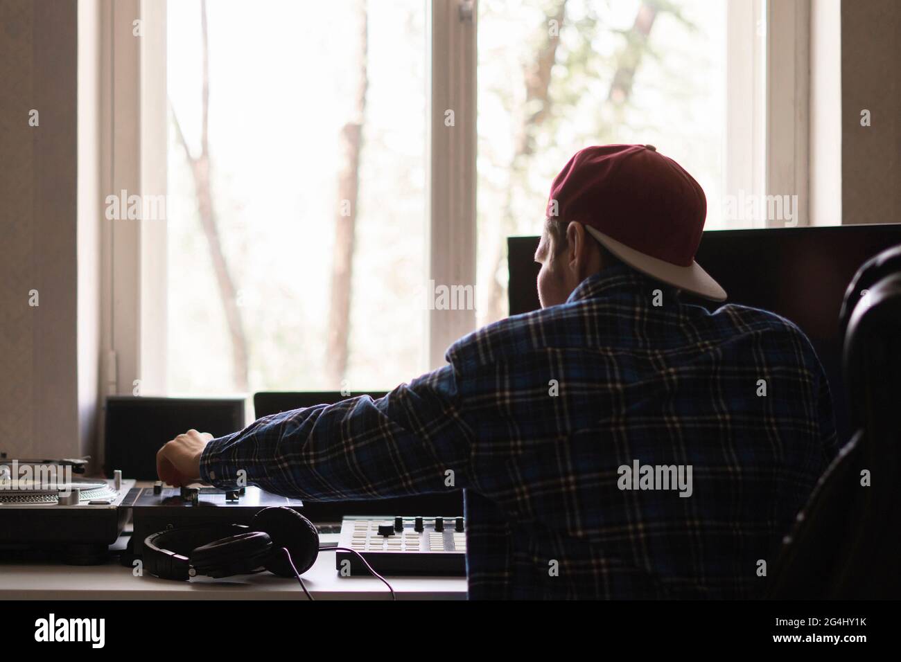 man in the home music studio, creating new song, making sound ...