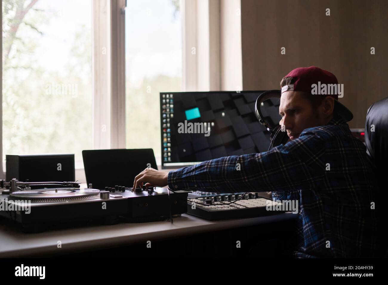 man in the home music studio, creating new song, making sound ...