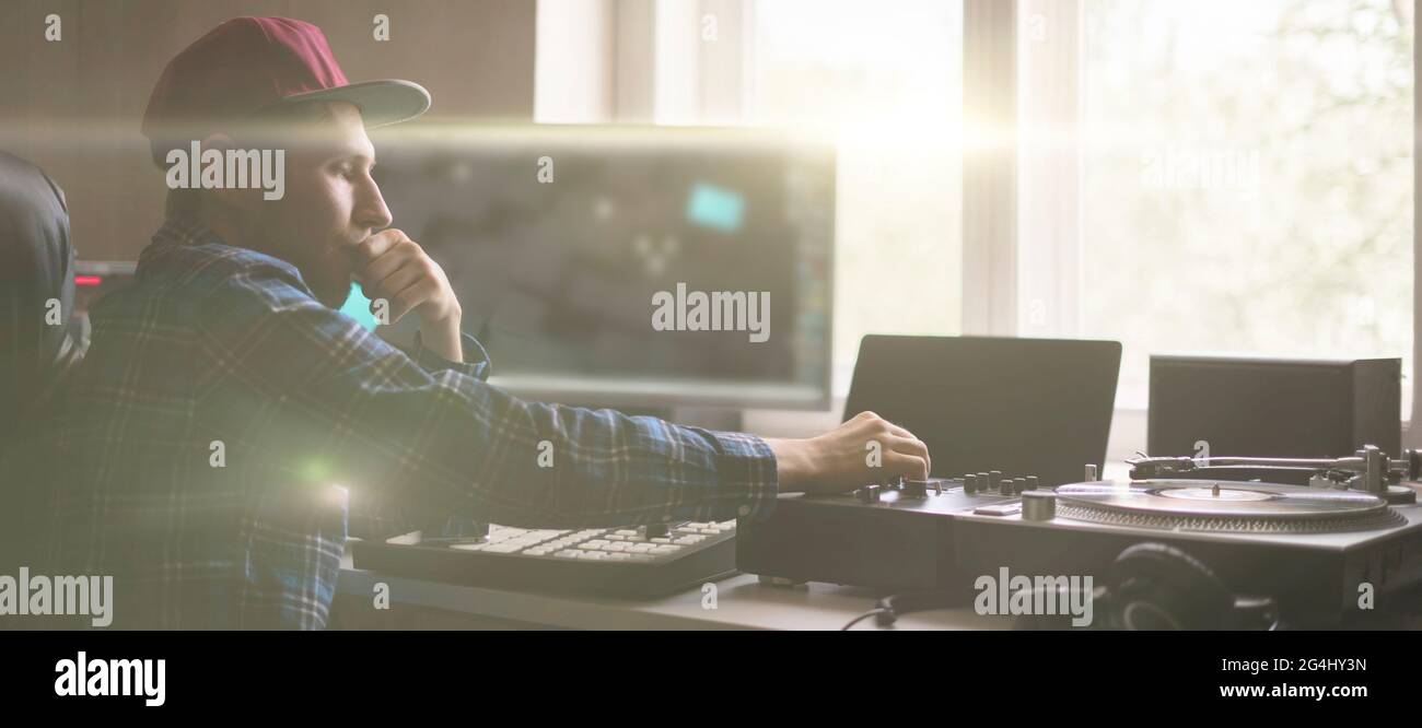 man in the home music studio, creating new song, making sound ...