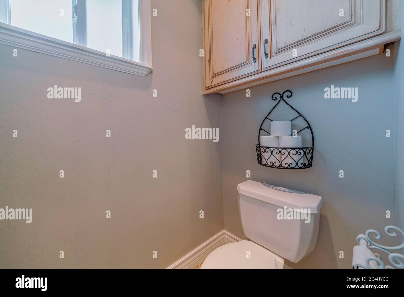 a flush toilet with wooden shelves and window in a white bathroom Stock ...