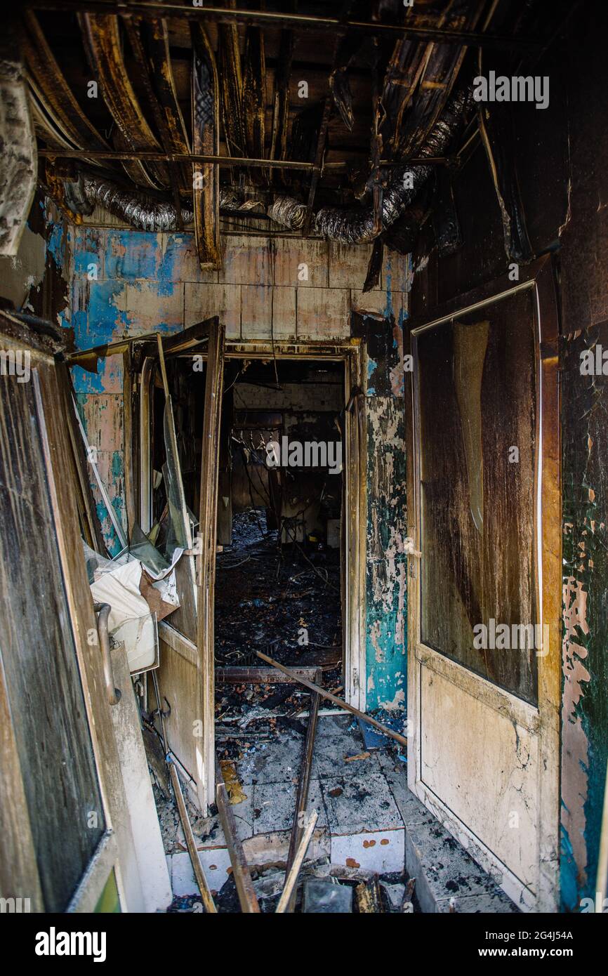 Burnt out shop after fire with charred door Stock Photo - Alamy