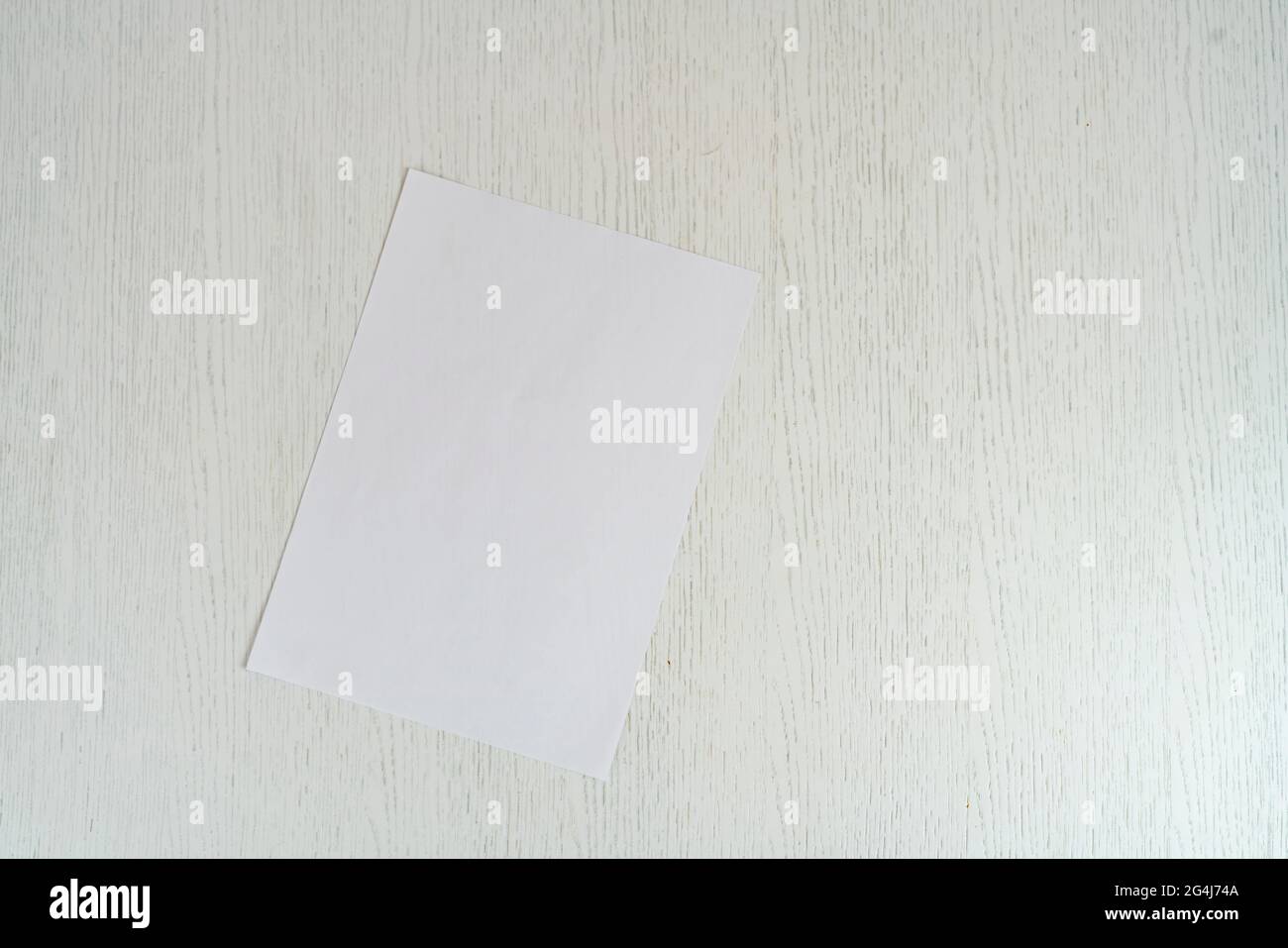 blank empty white paper sheet of a4 format on the table in office ...