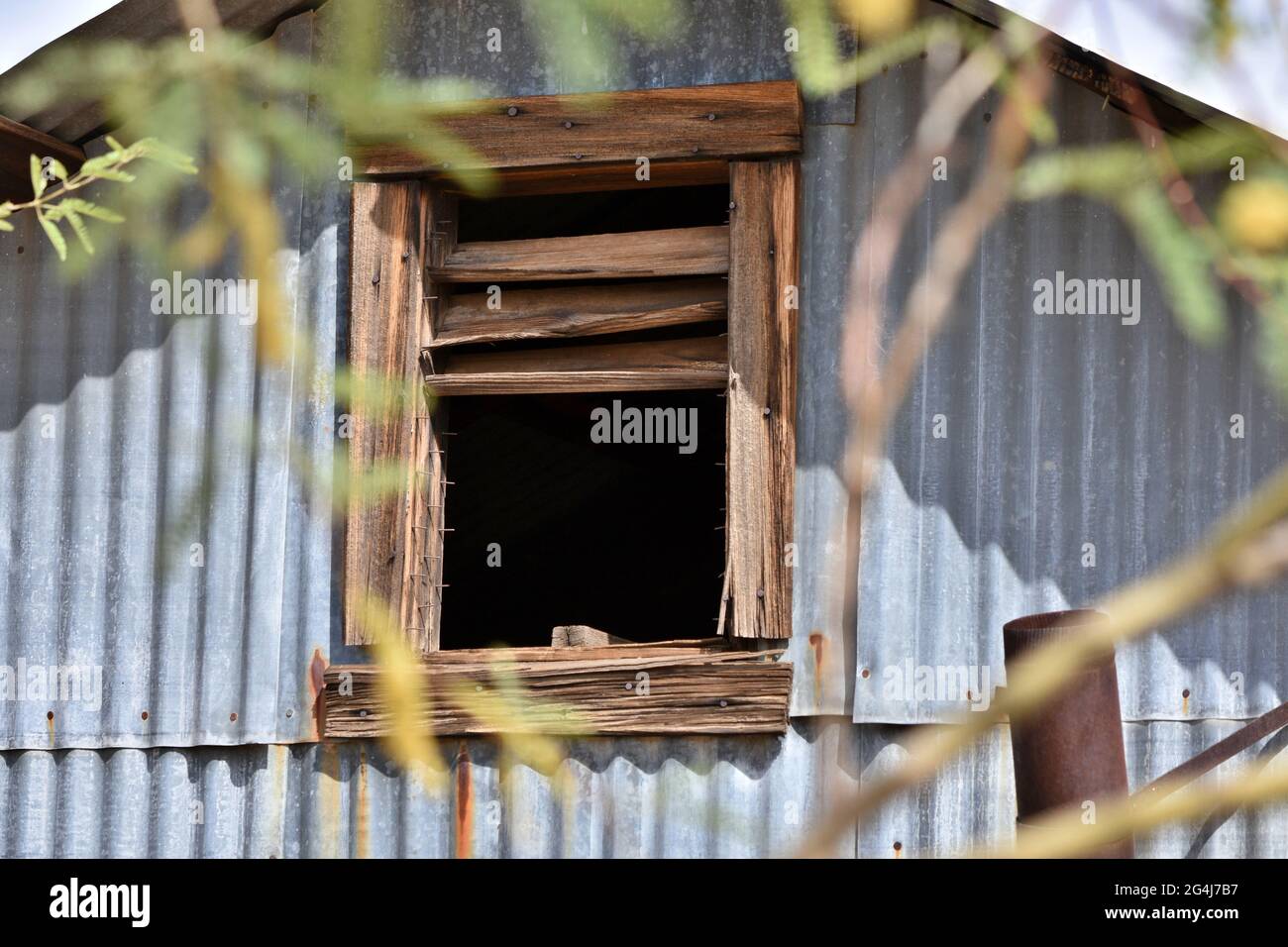 An old wooden window in a metal shed Stock Photo - Alamy
