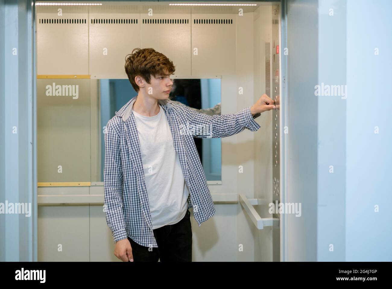 young man in casual come inside the lift elevator cabin Stock Photo - Alamy