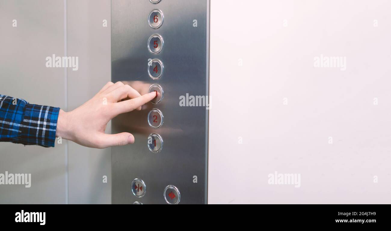 a close up hand pushing a button in the lift elevator cabin Stock Photo ...
