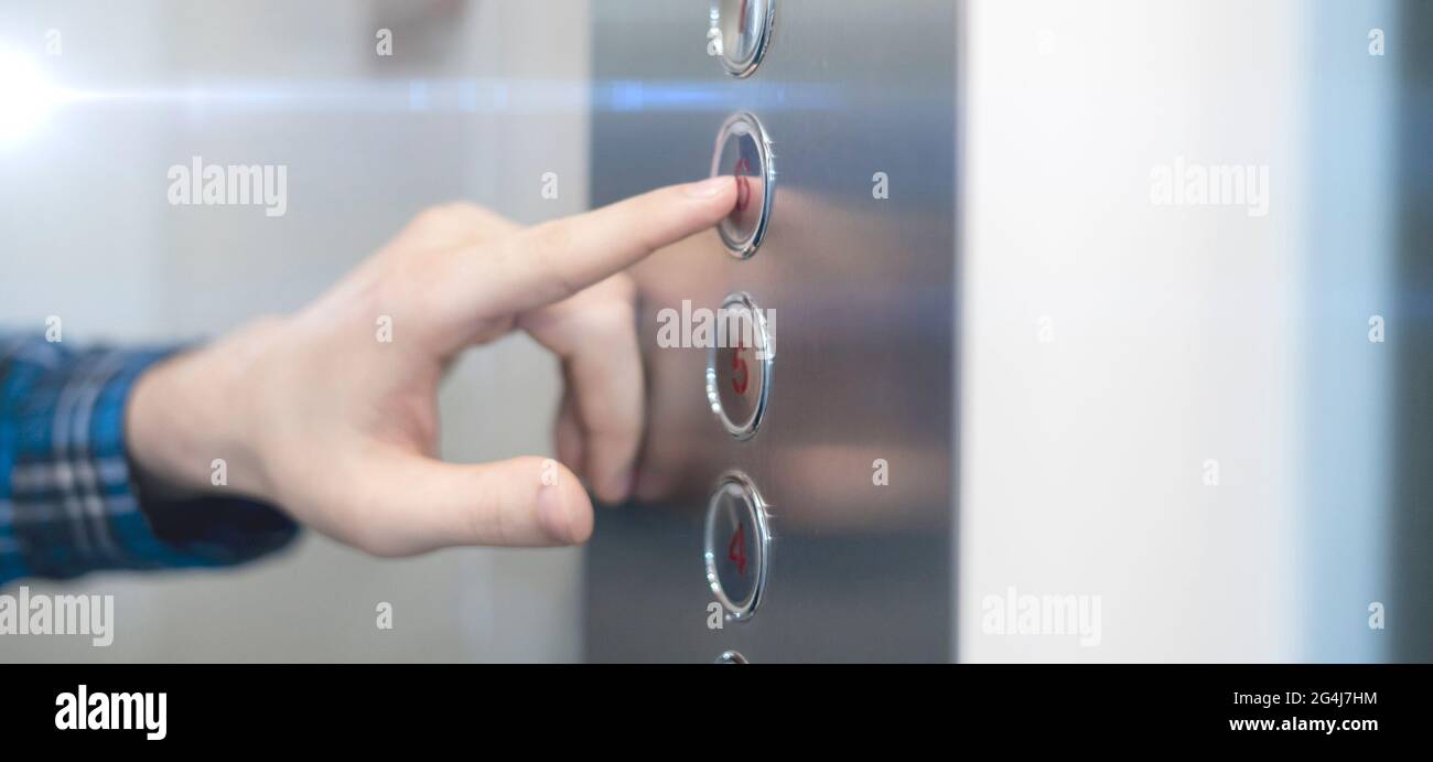 a close up hand pushing a button in the lift elevator cabin Stock Photo ...