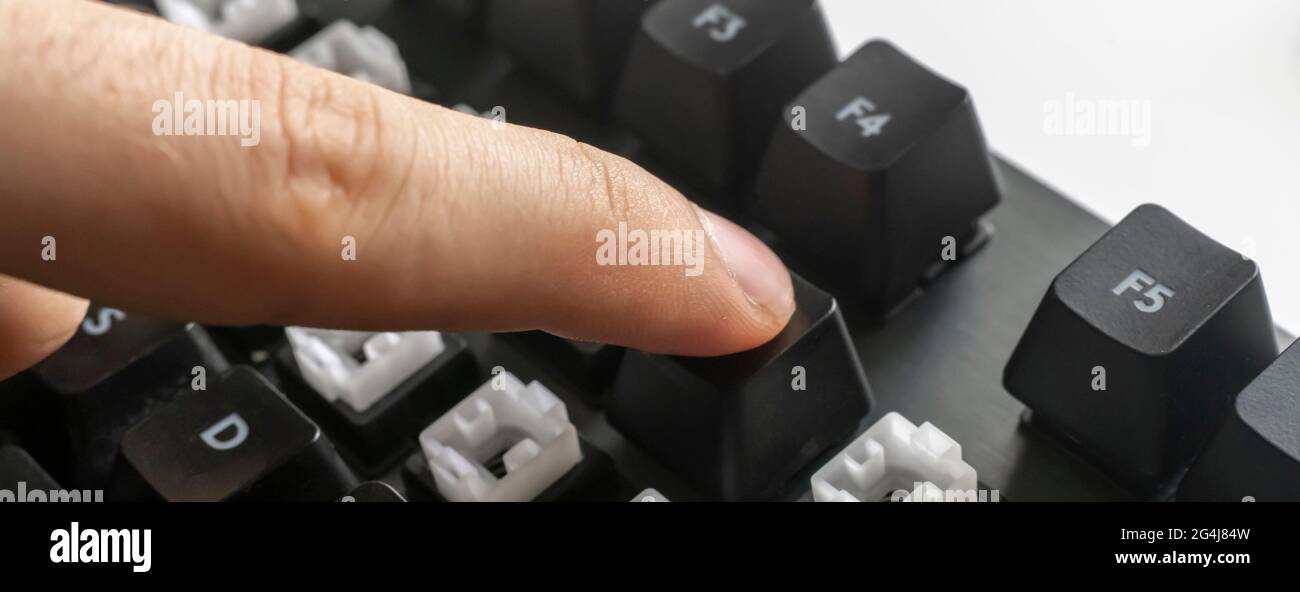 gamer push the button on a mechanical keyboard with mechanical switches ...