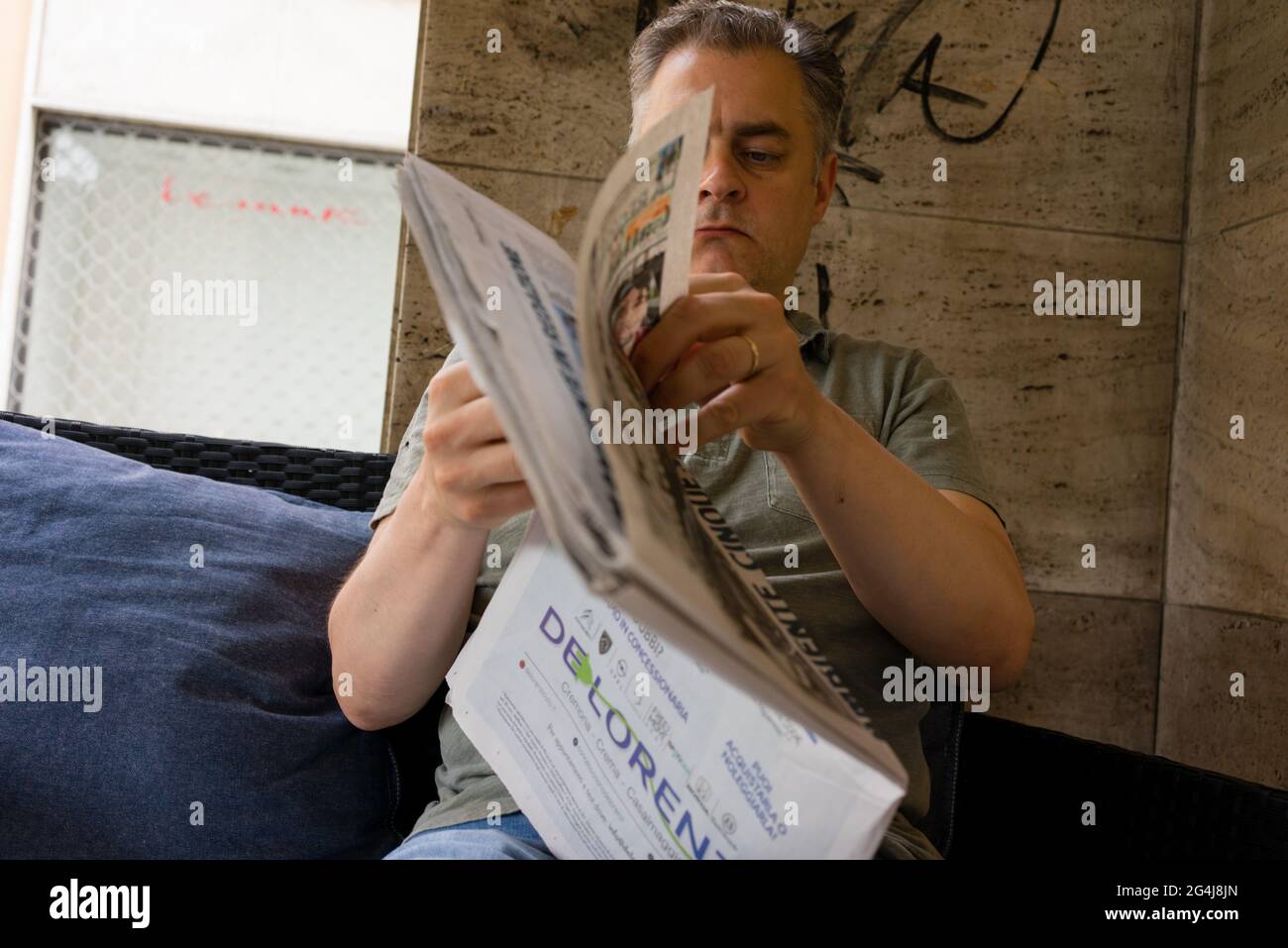 CREMONA, ITALY - Jun 19, 2021: adult caucasian italian man reading ...