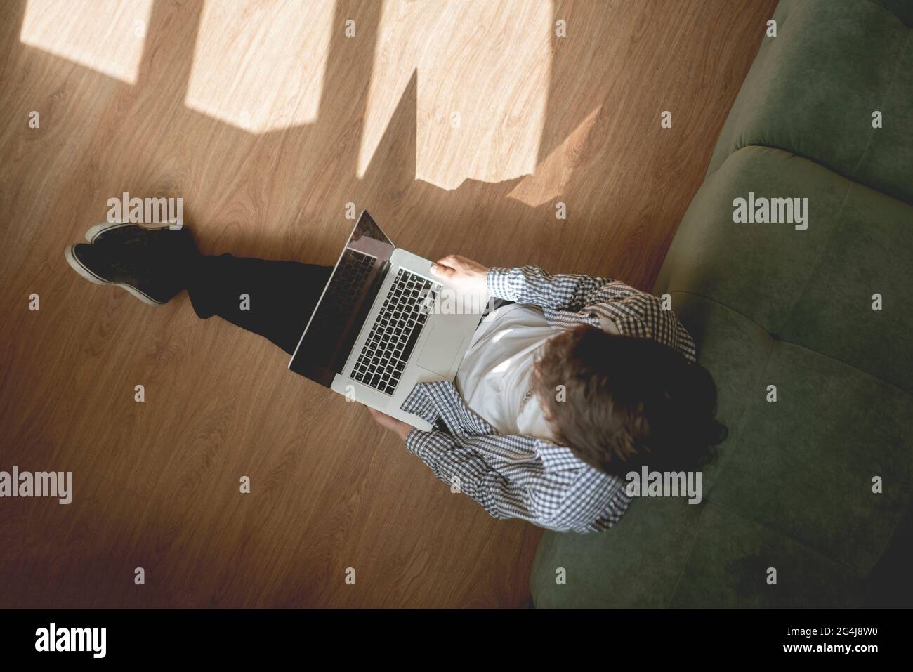 top overhead view of male person laying on the floor and working on the ...