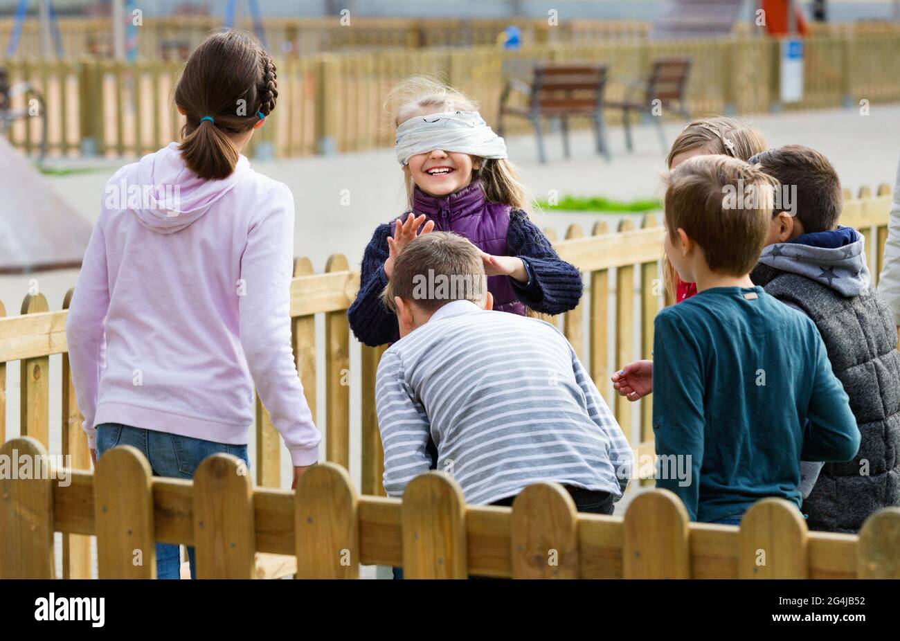 Laughing children playing at Blind man bluff Stock Photo - Alamy