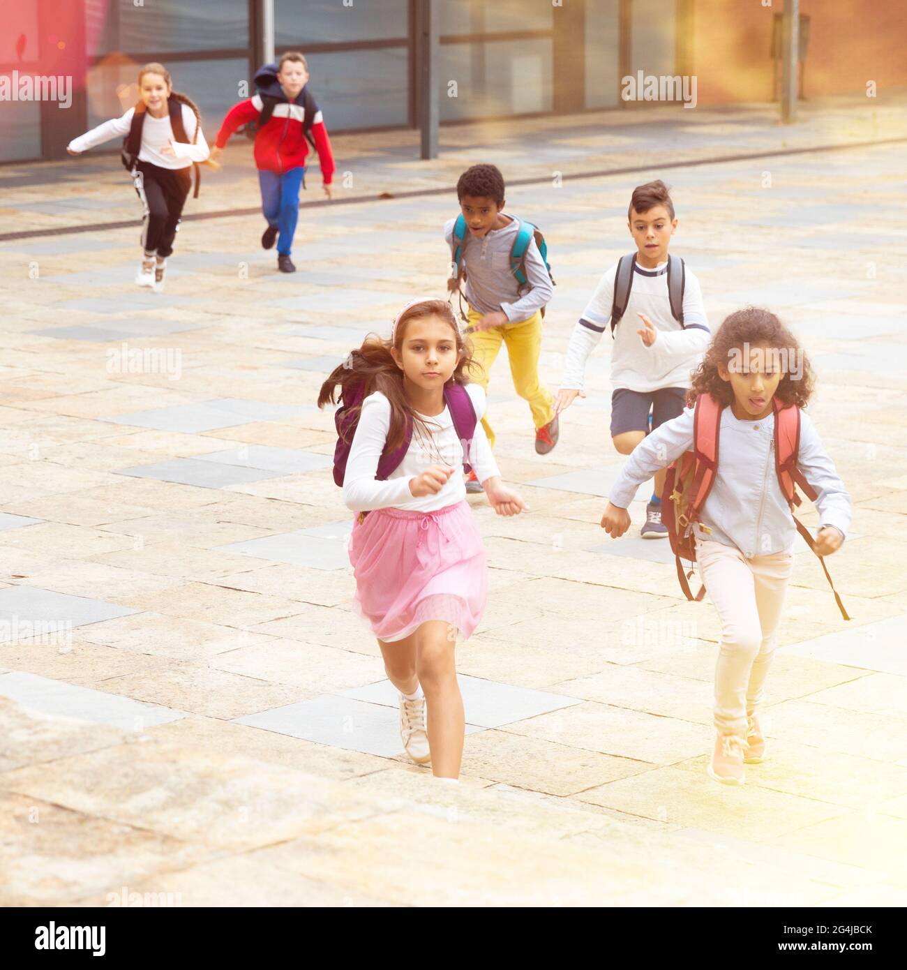 Happy schoolchildren running in the race from school outdoors Stock ...