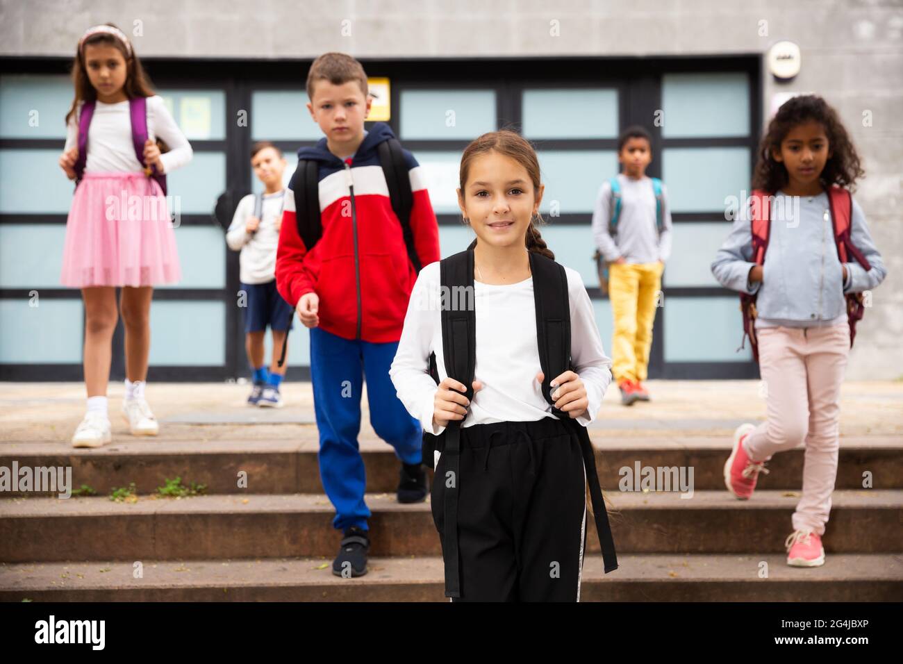 Smiling tween schoolgirl going to school on autumn day Stock Photo - Alamy