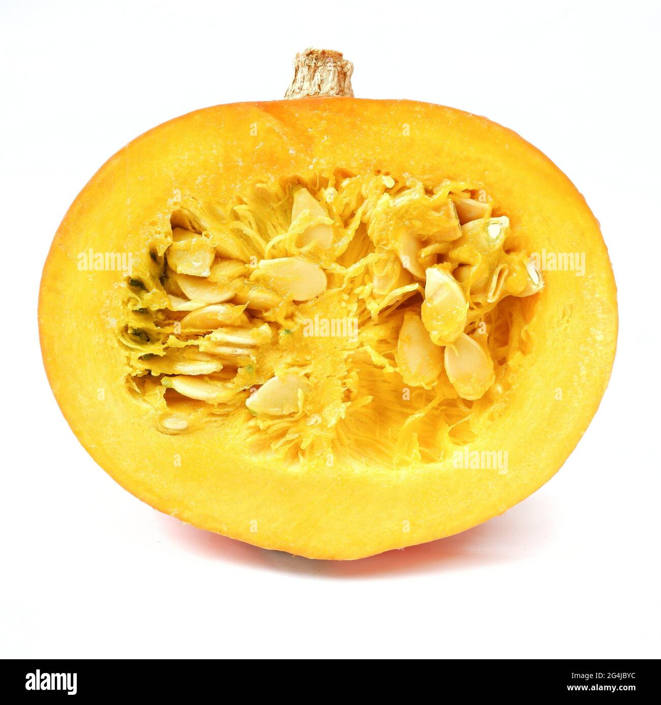 Cut in a half, ripe pumpkin with seeds isolated on a white background ...