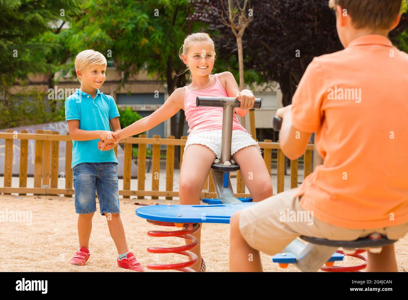 children are teetering on the swing in the playground Stock Photo - Alamy