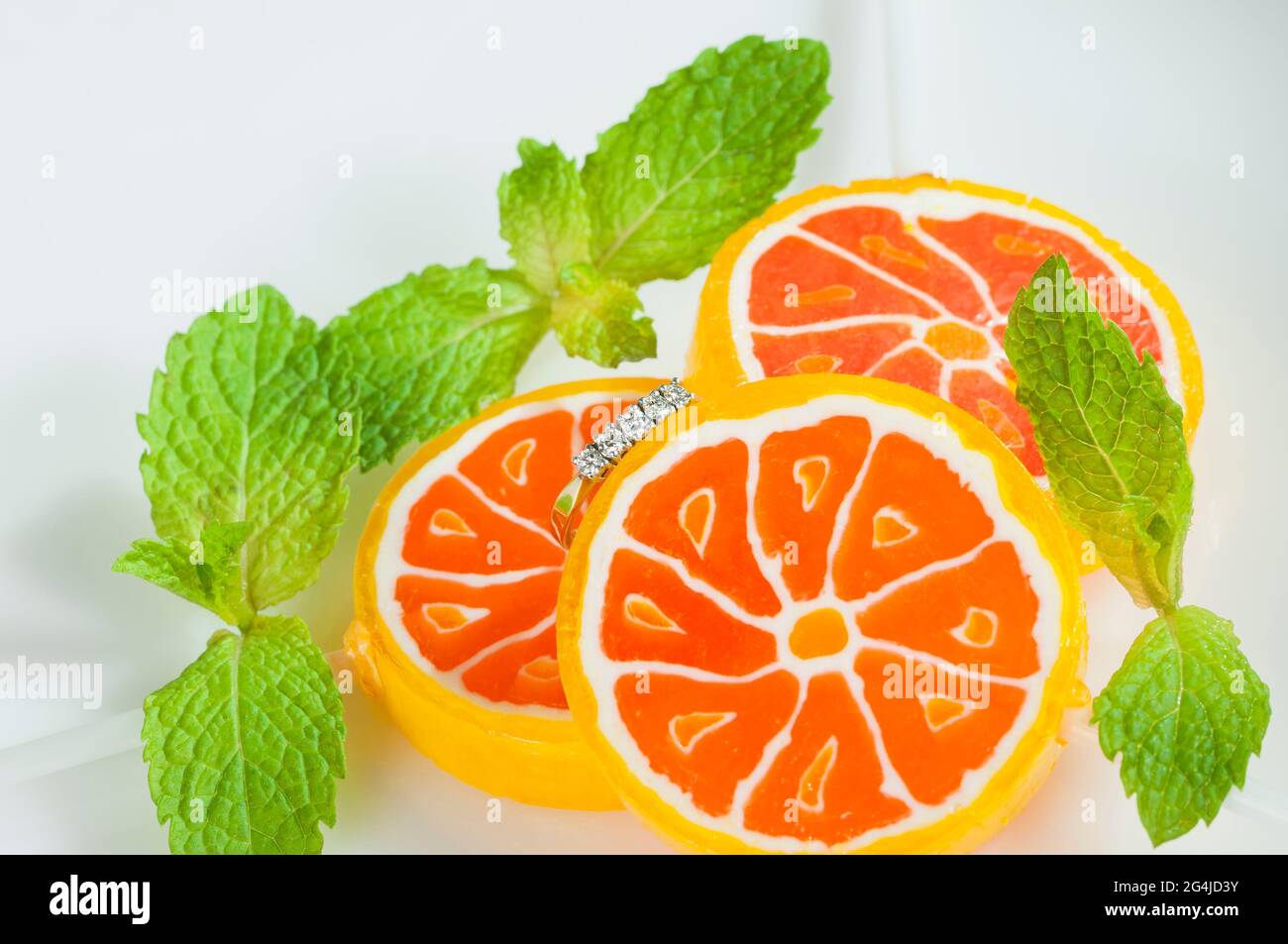 A diamond ring surrounded by an unusual setting of sweet candies and ...