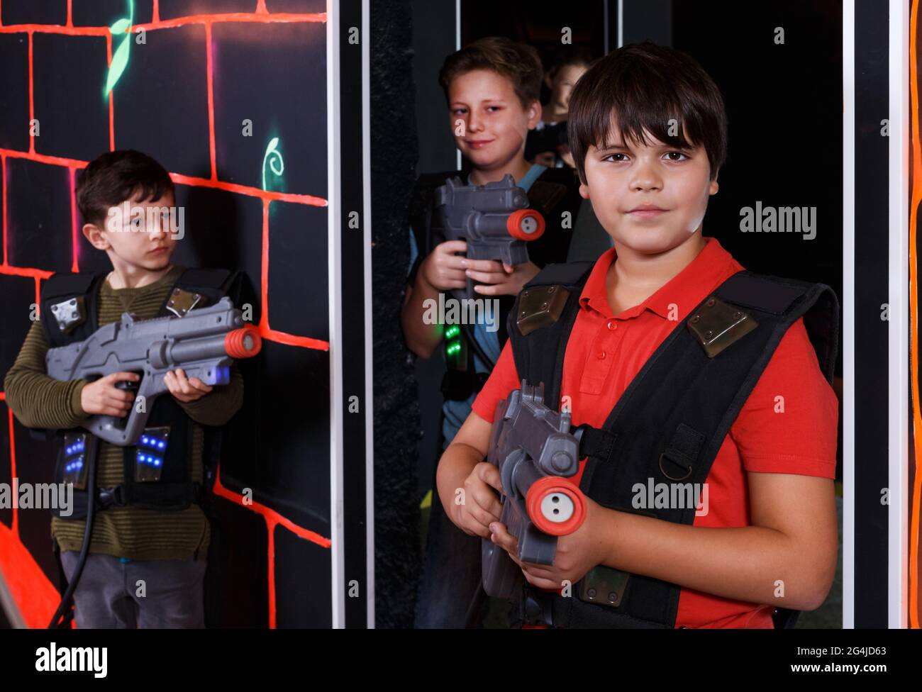 boy aiming laser gun at other players during lasertag game Stock Photo ...